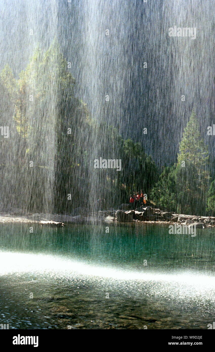 Tourists look at a waterfall in the Yandang Mountain senic spot in ...
