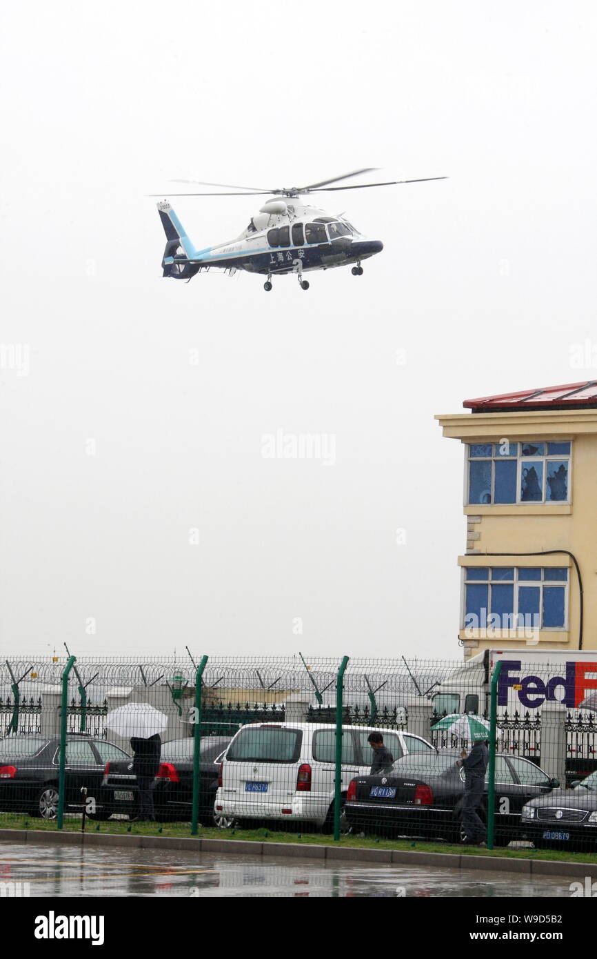 A police helicopter is seen flying during a drill at a helicopter base ...