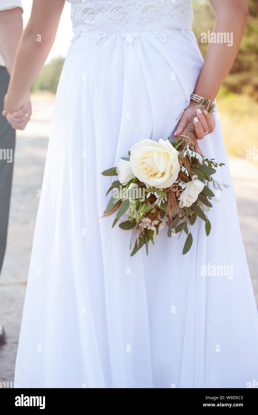 Bride holds bridal bouquet hi-res stock photography and images - Alamy