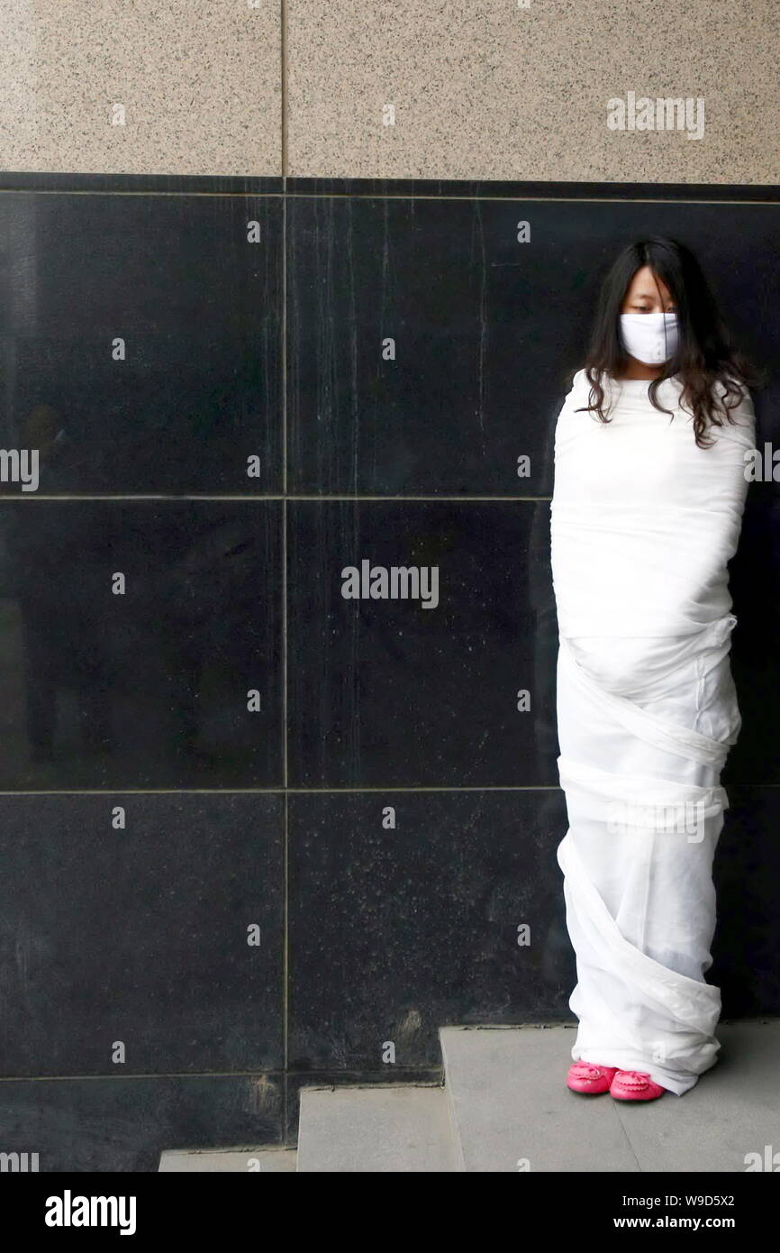 A colleage student who wrapped her body with gauze poses to show ...