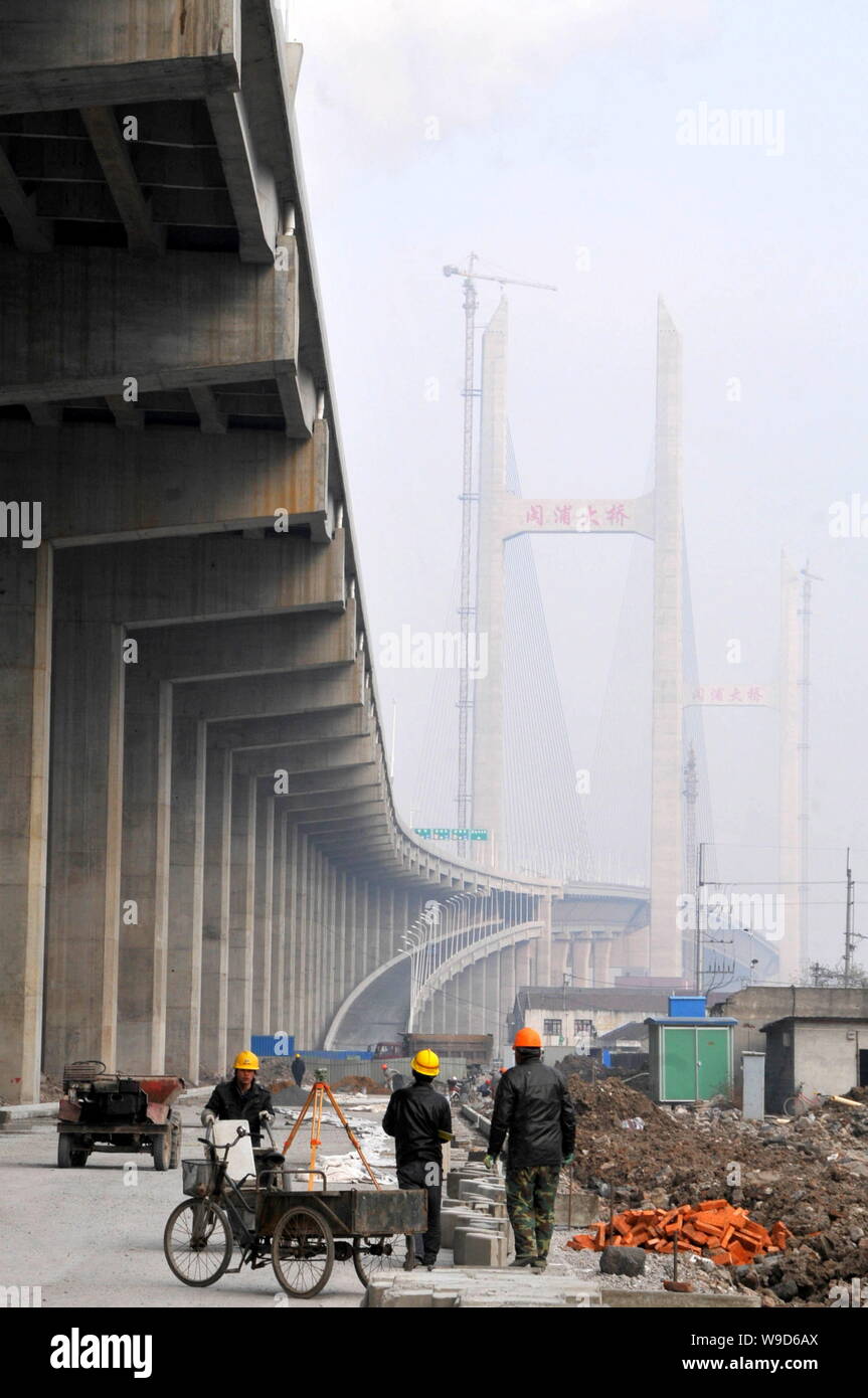 Chinese workers check and put final touches on the Minpu Bridge in ...