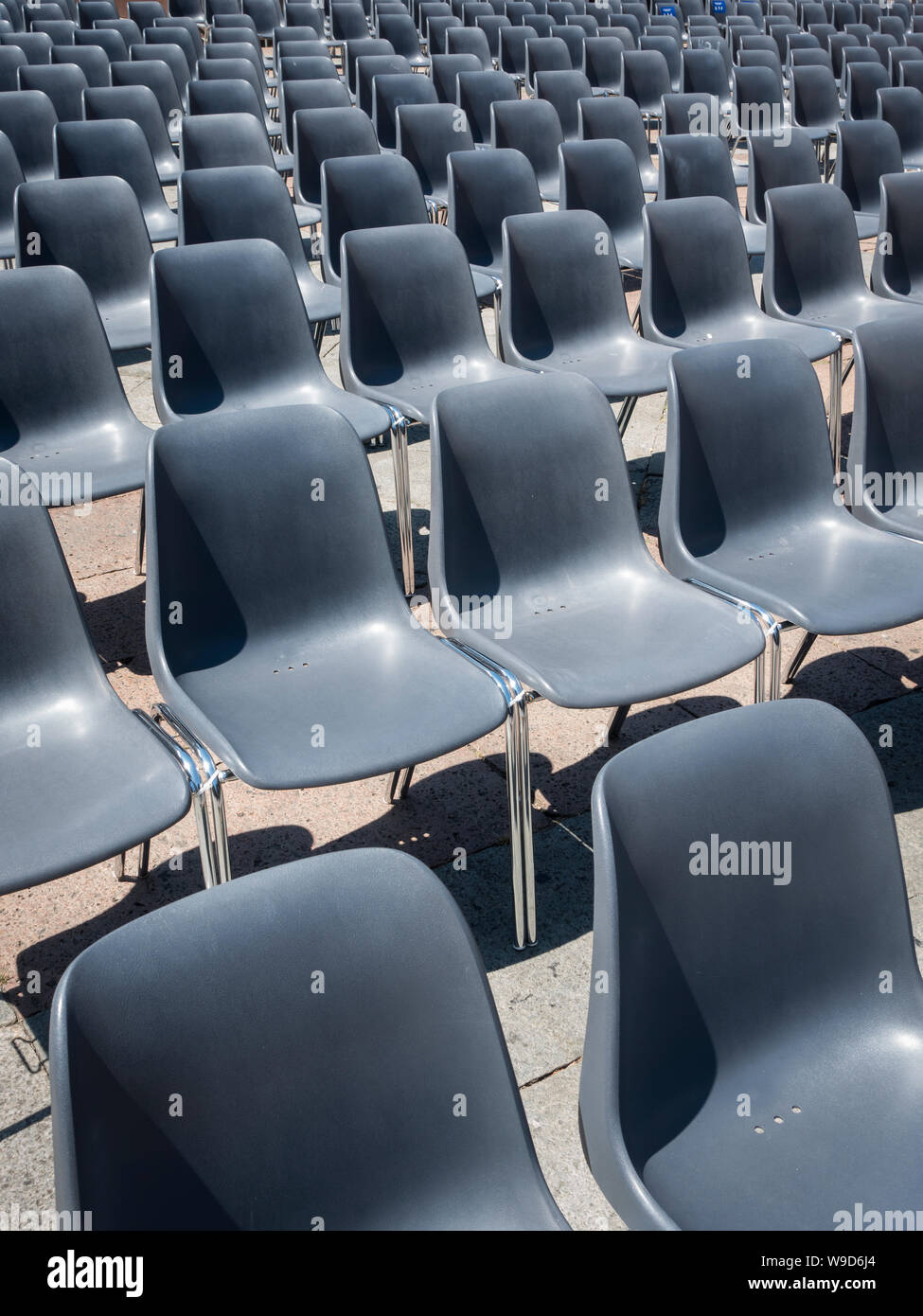 Series of plastic chairs in a square Stock Photo - Alamy