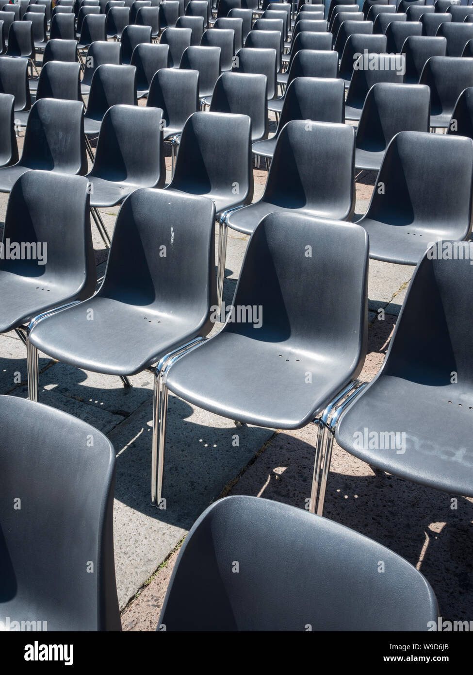 Series of plastic chairs in a square Stock Photo - Alamy