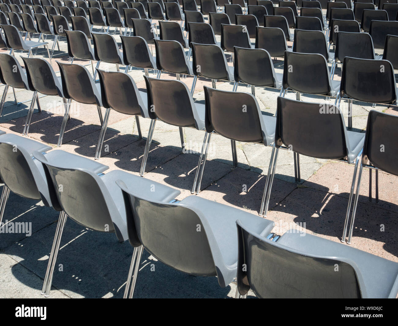 Series of plastic chairs in a square Stock Photo - Alamy