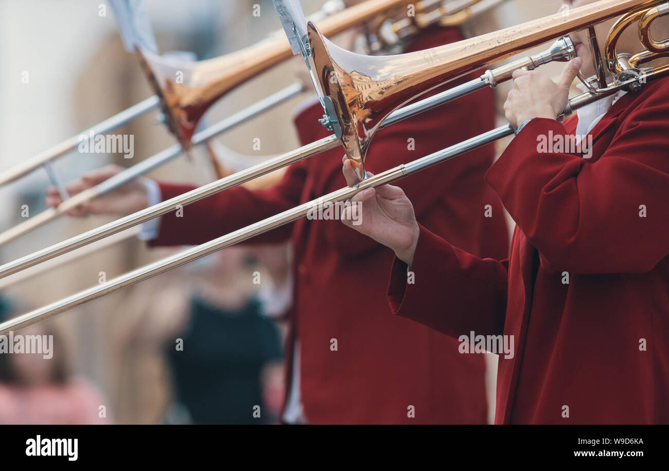 A wind instrument parade - men in red costumes playing trumpet Stock ...