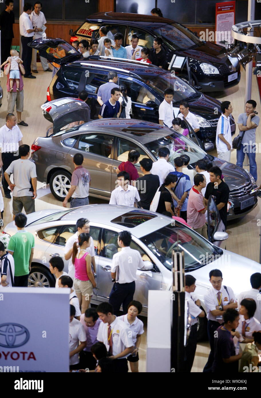 --FILE--Visitors look at Toyota cars on display during an auto show in ...
