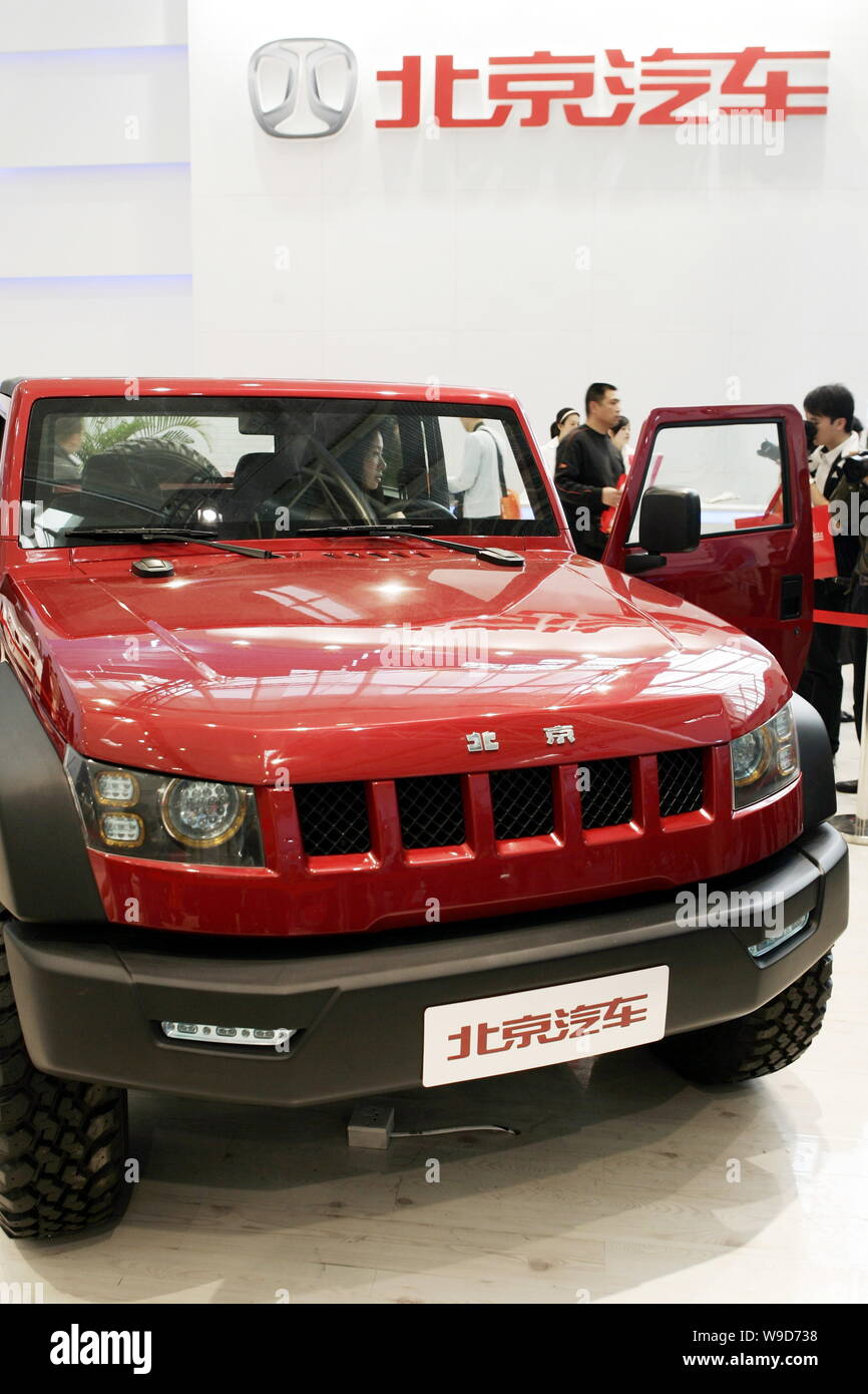 --FILE--Chinese visitors look at a car manufactured by BAIC (Beijing ...