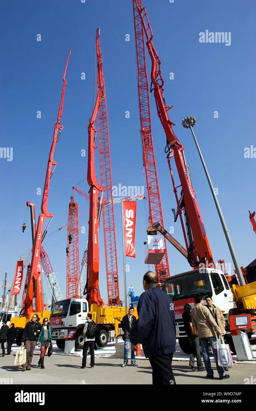 --FILE--Visitors look at Sany construction machines on display during ...