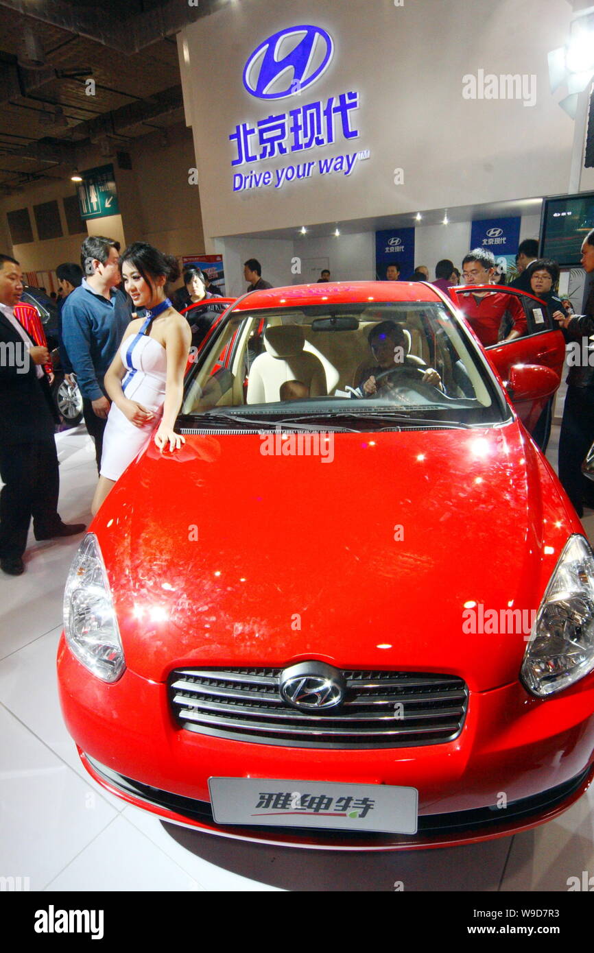 --FILE--Chinese visitors look at an Accent of Beijing Hyundai, the ...