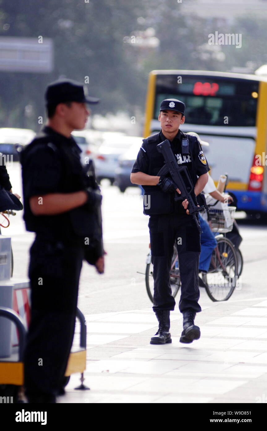 Armed Chinese special policemen patrol a street in Beijing, China, 12 ...