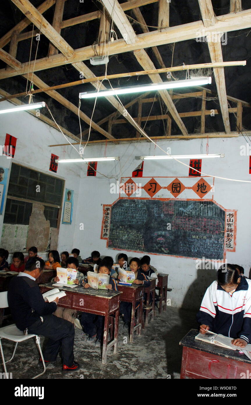A Chinese teacher gives a lesson to his pupils at the Zhongdong Hope ...
