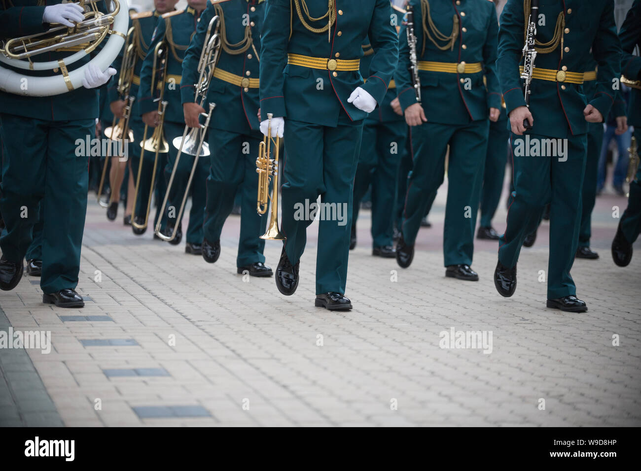 A wind instrument parade - people in green costumes marching Stock ...