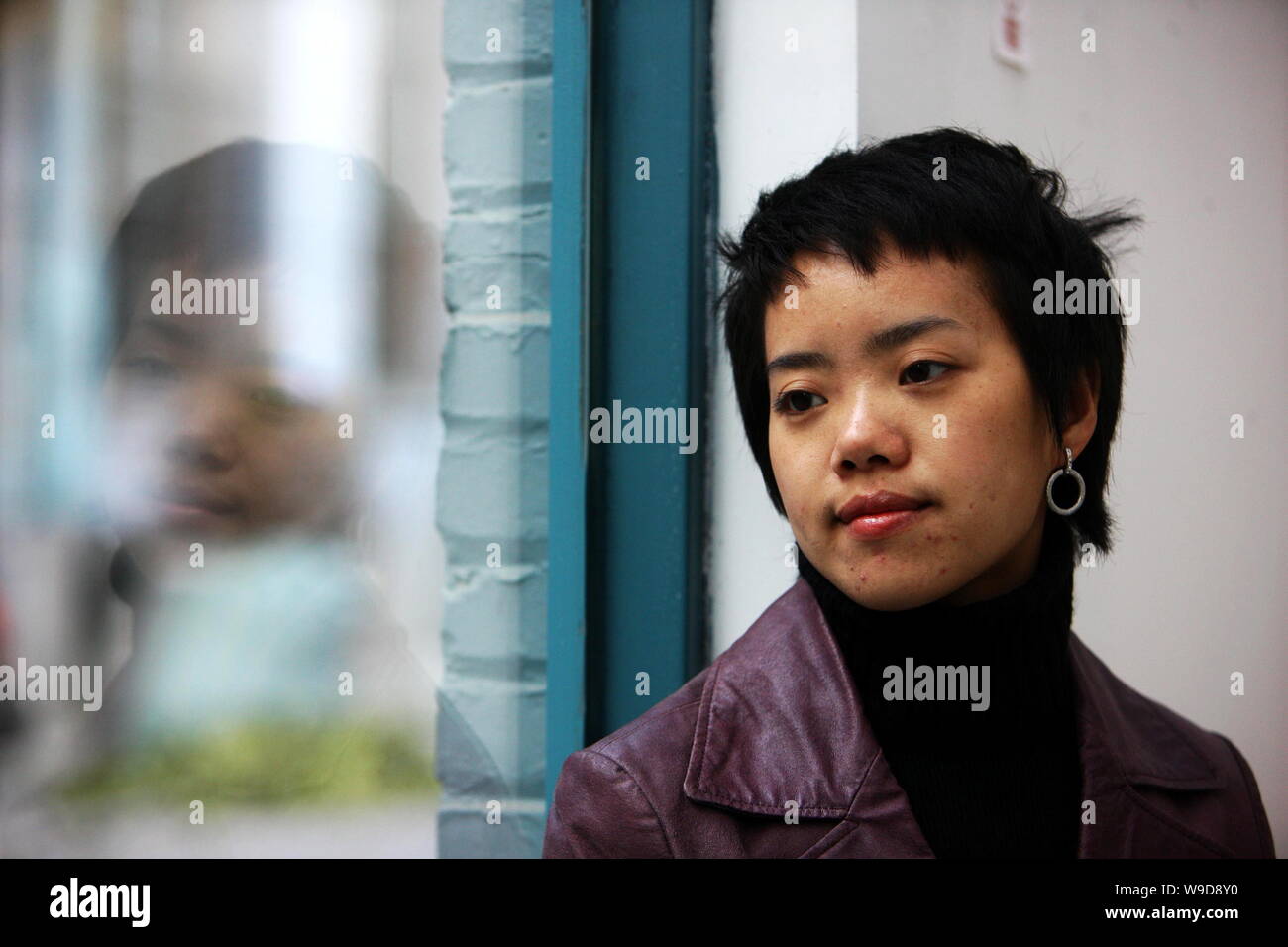 Chinese artist Ju Duoqi poses during her vegetable-made painting ...