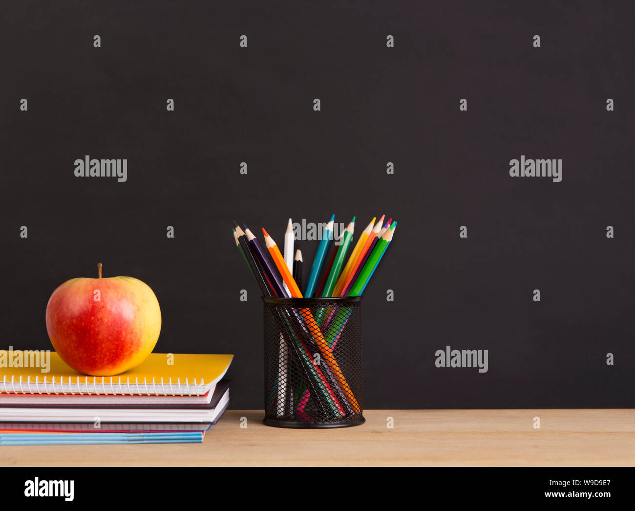Apple, pencils and notebooks ready for using Stock Photo - Alamy