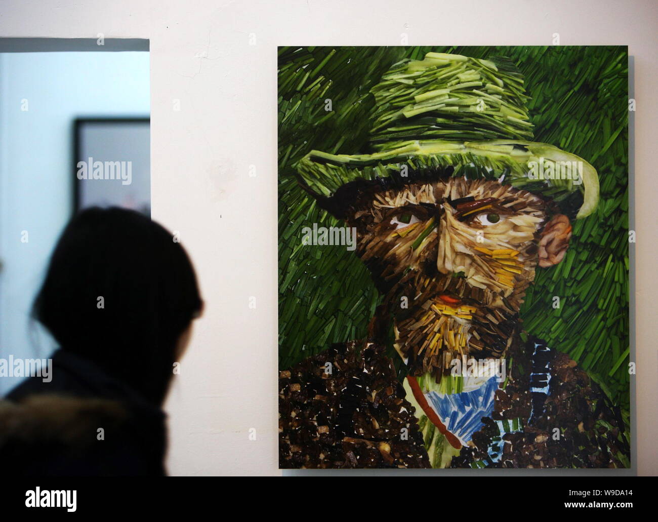 A visitor looks at a vegetable-made replica of a Van Gogh Self-Portrait ...