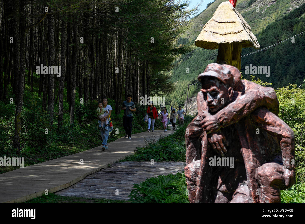 Guyuan. 12th Aug, 2019. Visitors walk along a "Red Army path" at the ...