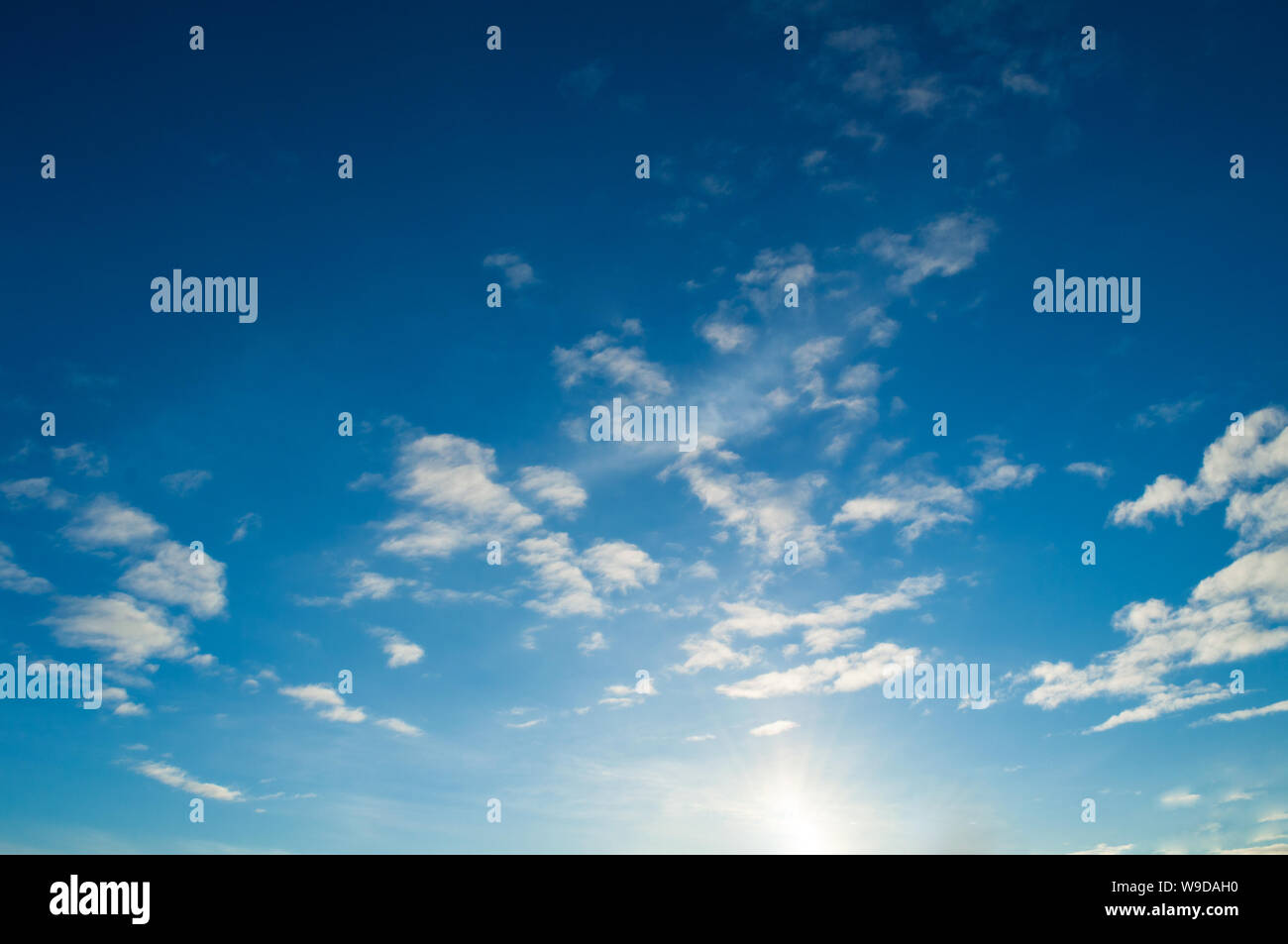 Blue dramatic sky background - white dramatic colorful clouds lit by ...