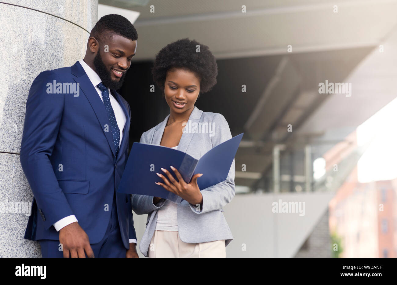Successful business partners checking financial reports outdoors Stock ...