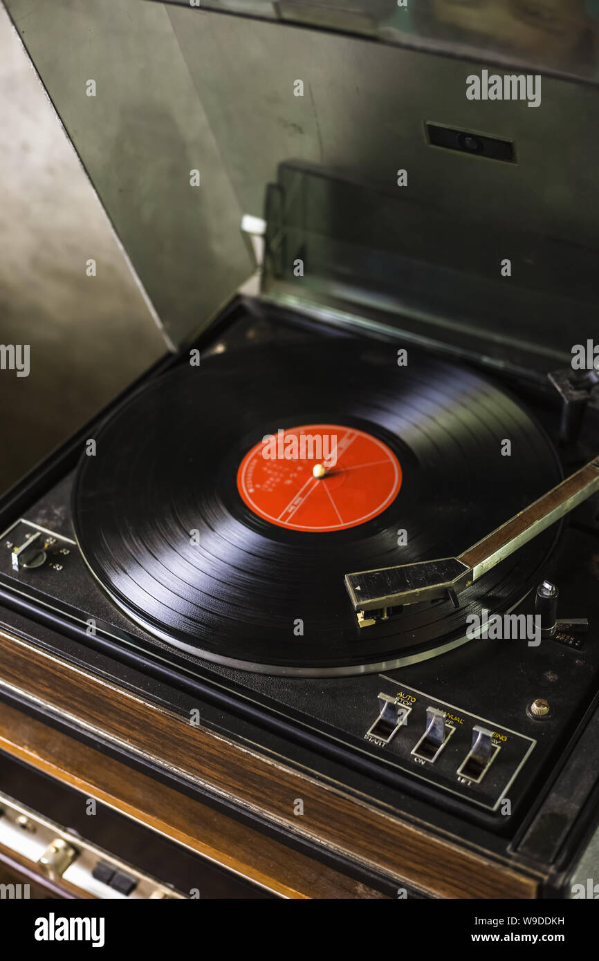 Vintage portable record player "Phonograph" with a vinyl record disk ...