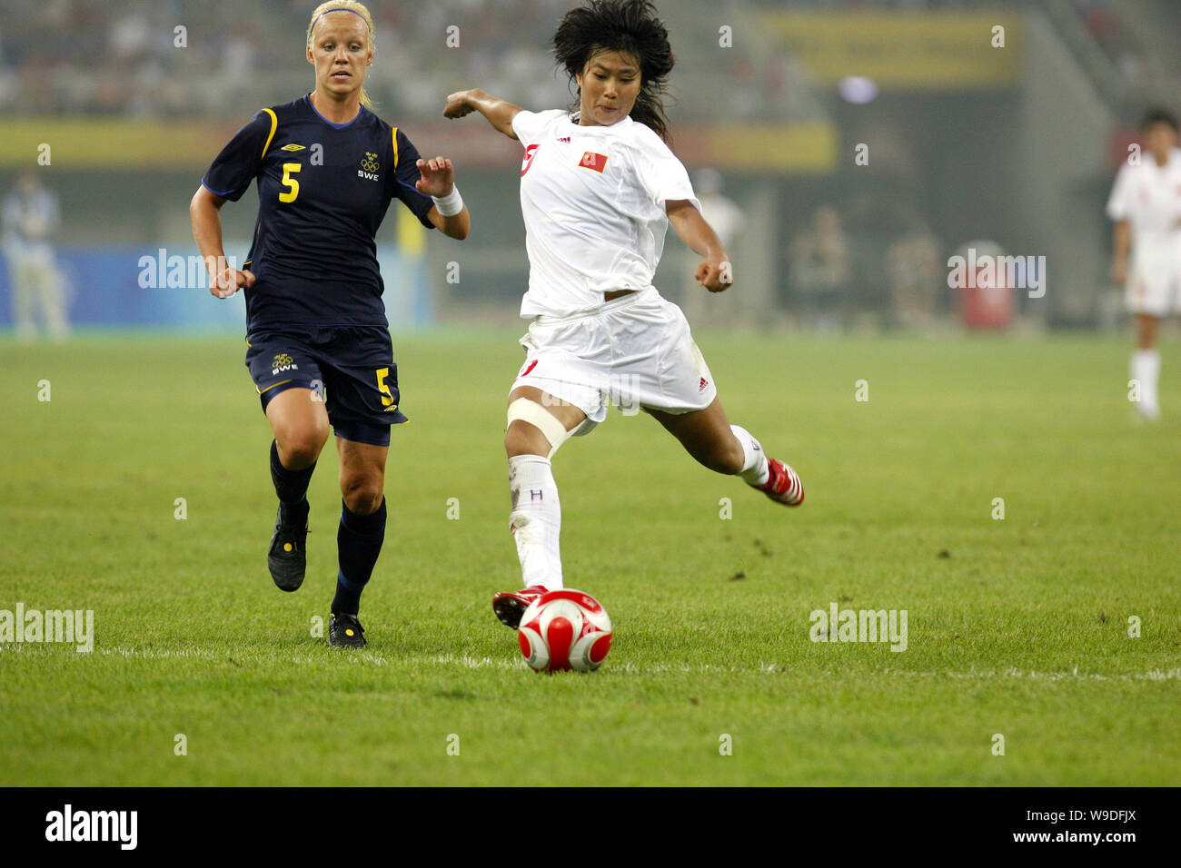 Caroline Seger of Sweden, left, tries to block a shot by Chinas Han ...