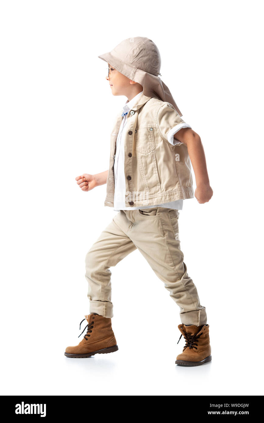 side view of explorer child in hat standing on white Stock Photo - Alamy