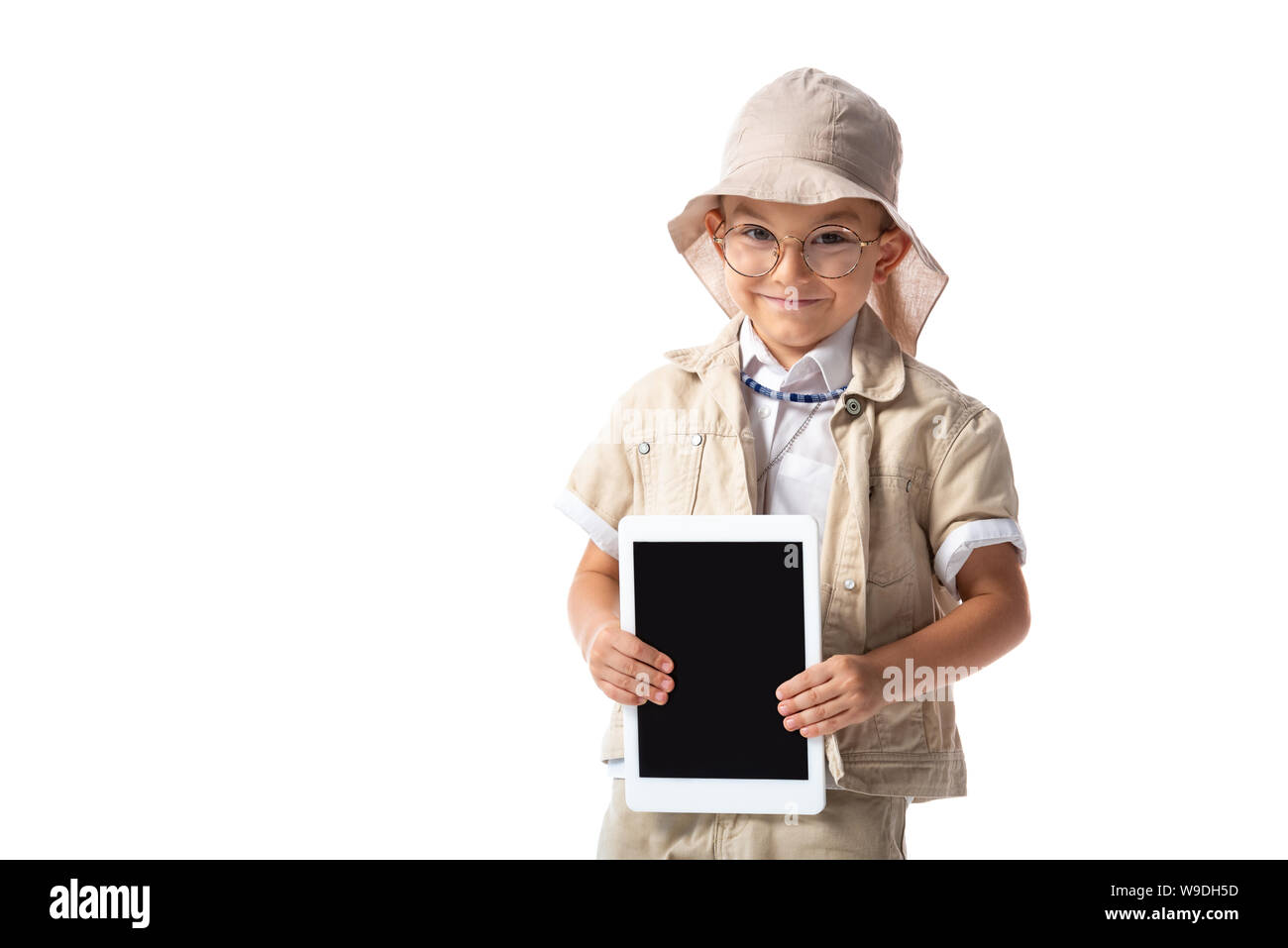 smiling explorer child in glasses and hat holding digital tablet with ...