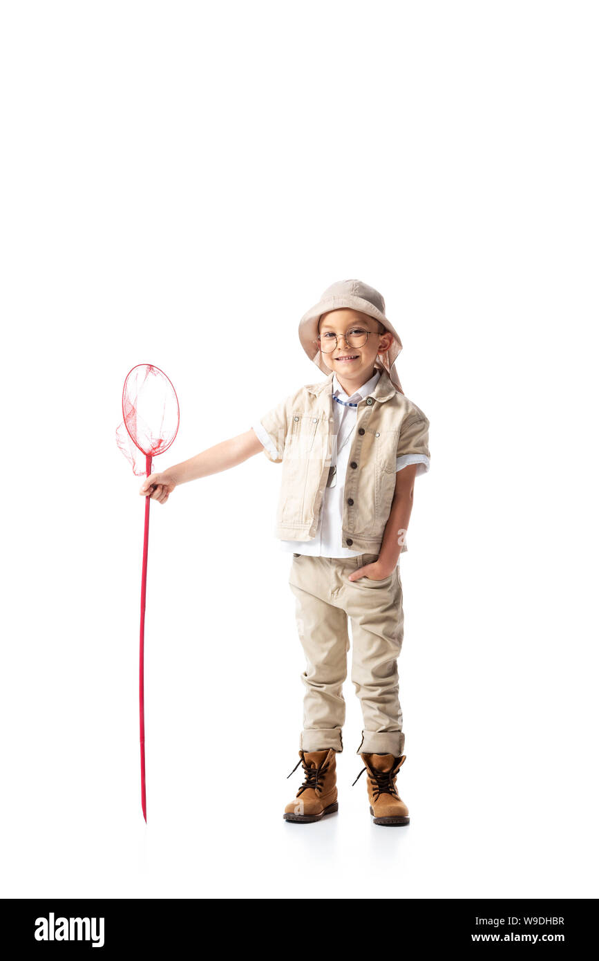 full length view of smiling explorer kid in hat holding butterfly net ...