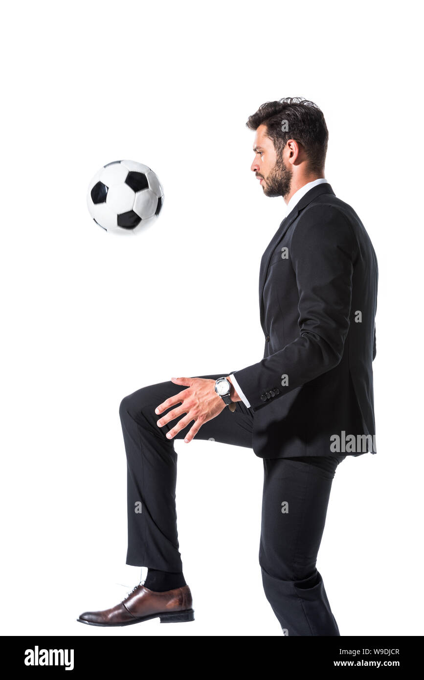 handsome businessman in formal wear training with soccer ball Isolated ...