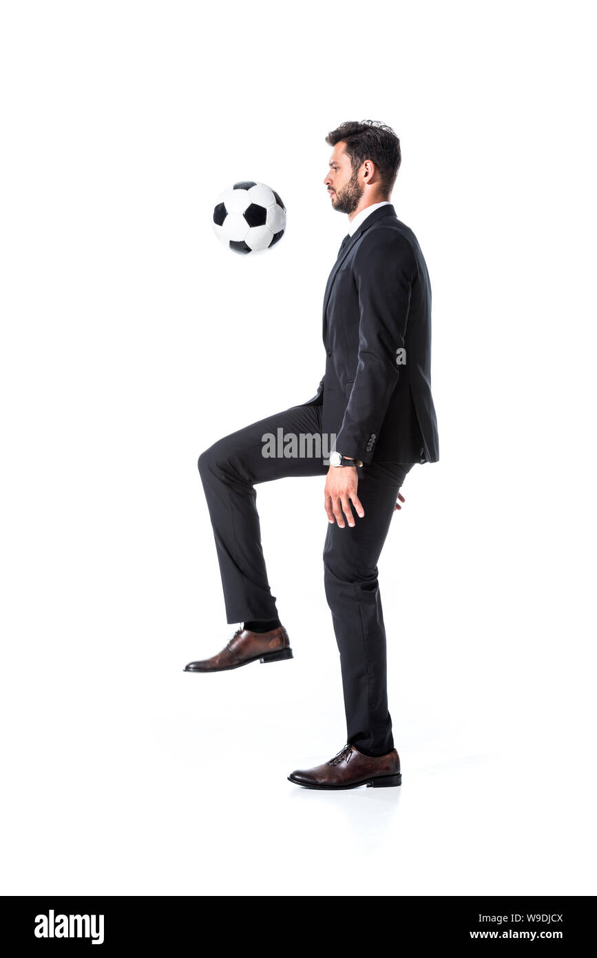 handsome businessman in formal wear training with soccer ball Isolated ...