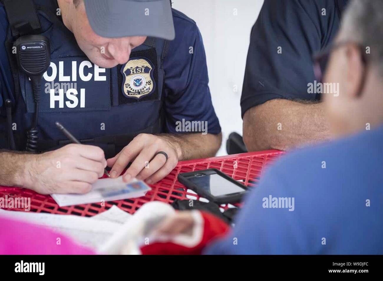 Customs officers detaining a person hi-res stock photography and images ...
