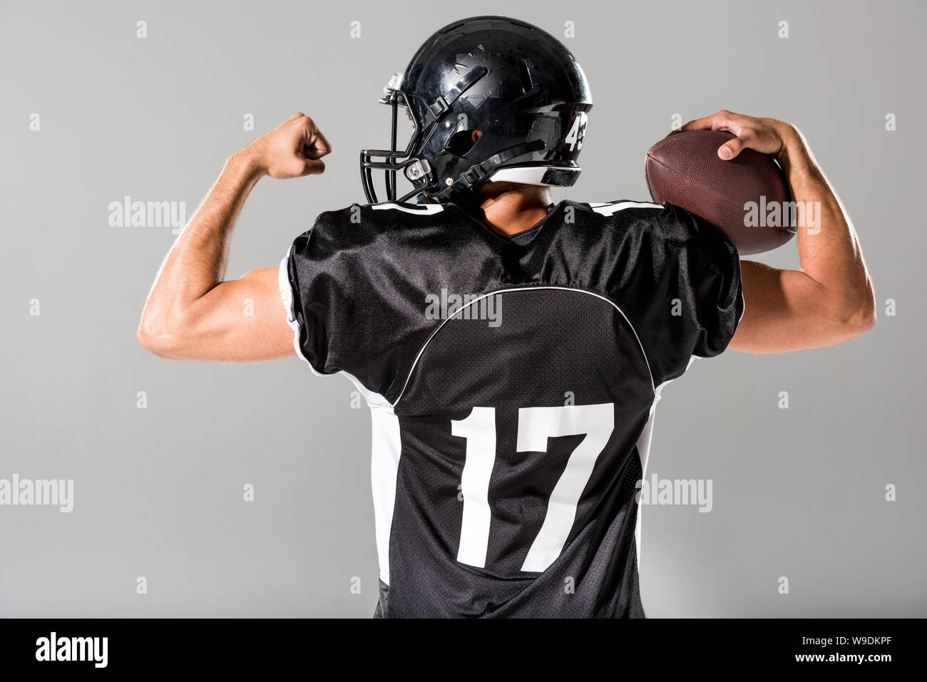 back view of American Football player with ball Isolated On grey Stock ...