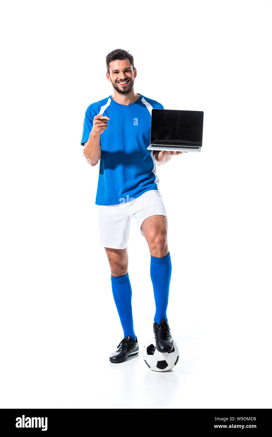 happy soccer player with laptop pointing with finger Isolated On White ...