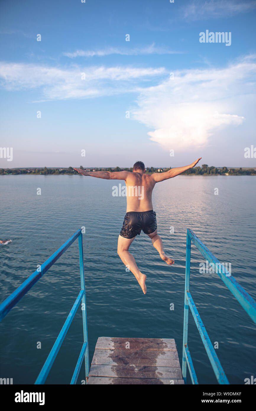 Rear view of man jumping into water hi-res stock photography and images ...