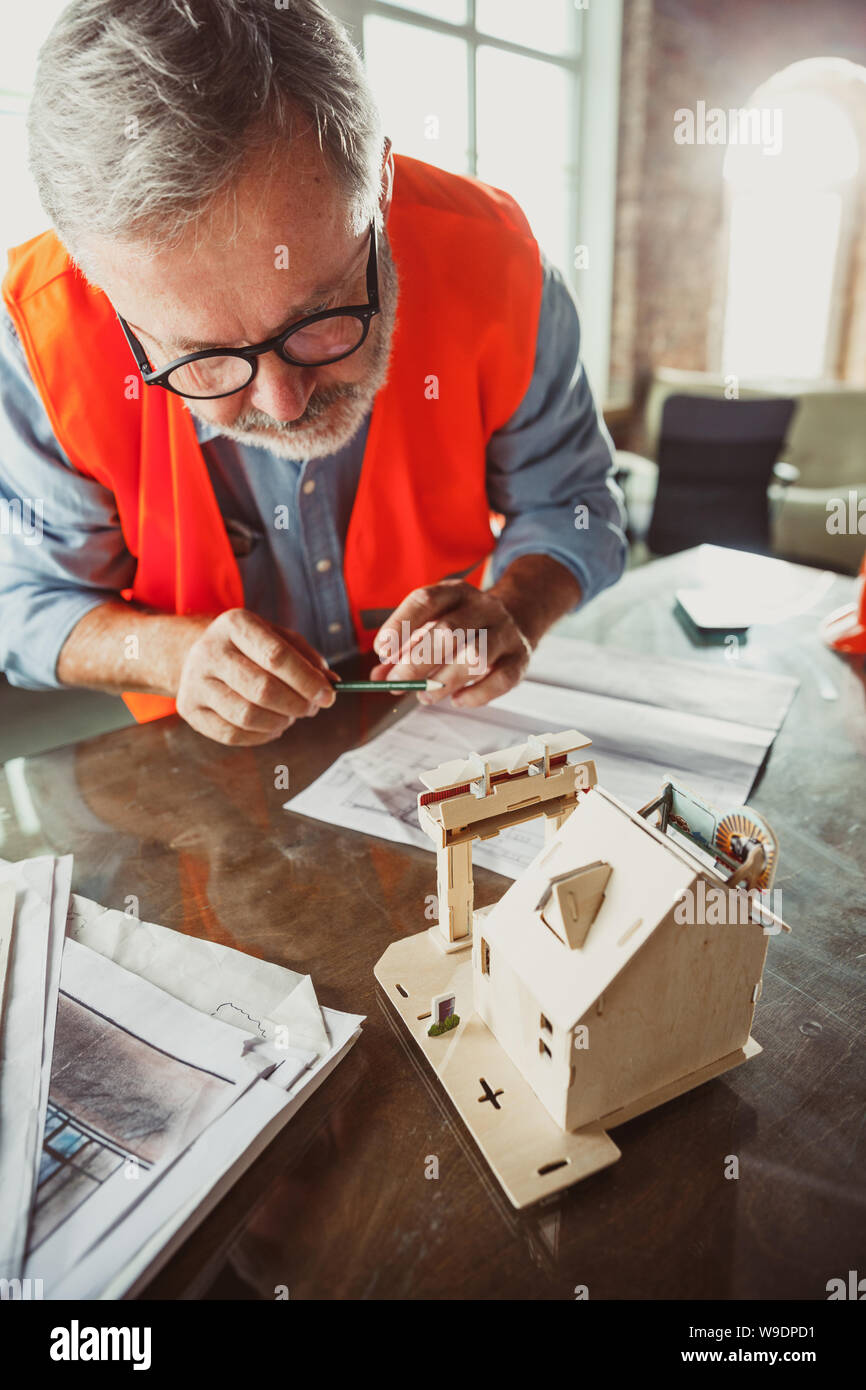 Close up photoshot of male architect-engineer making a model of future ...