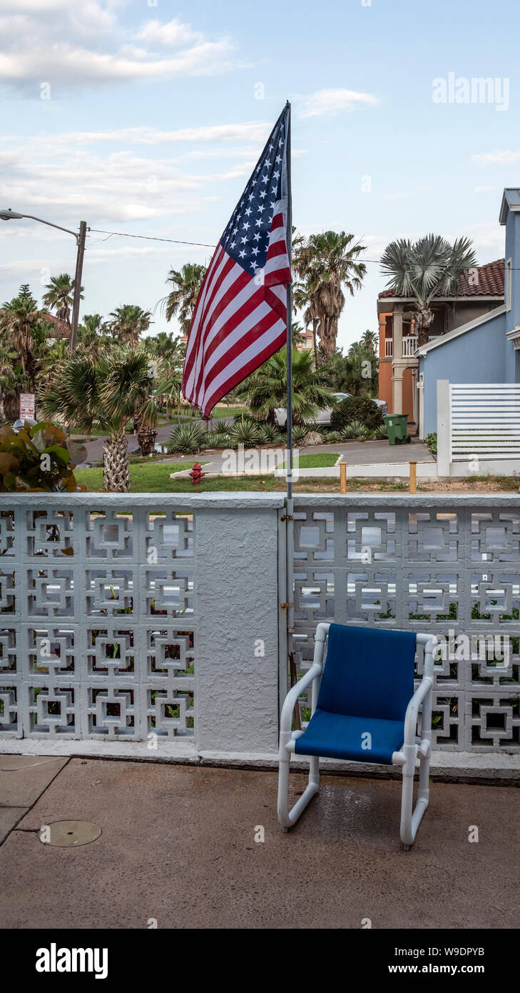 American flag and empty chair next to swimming pool, out of season, USA ...
