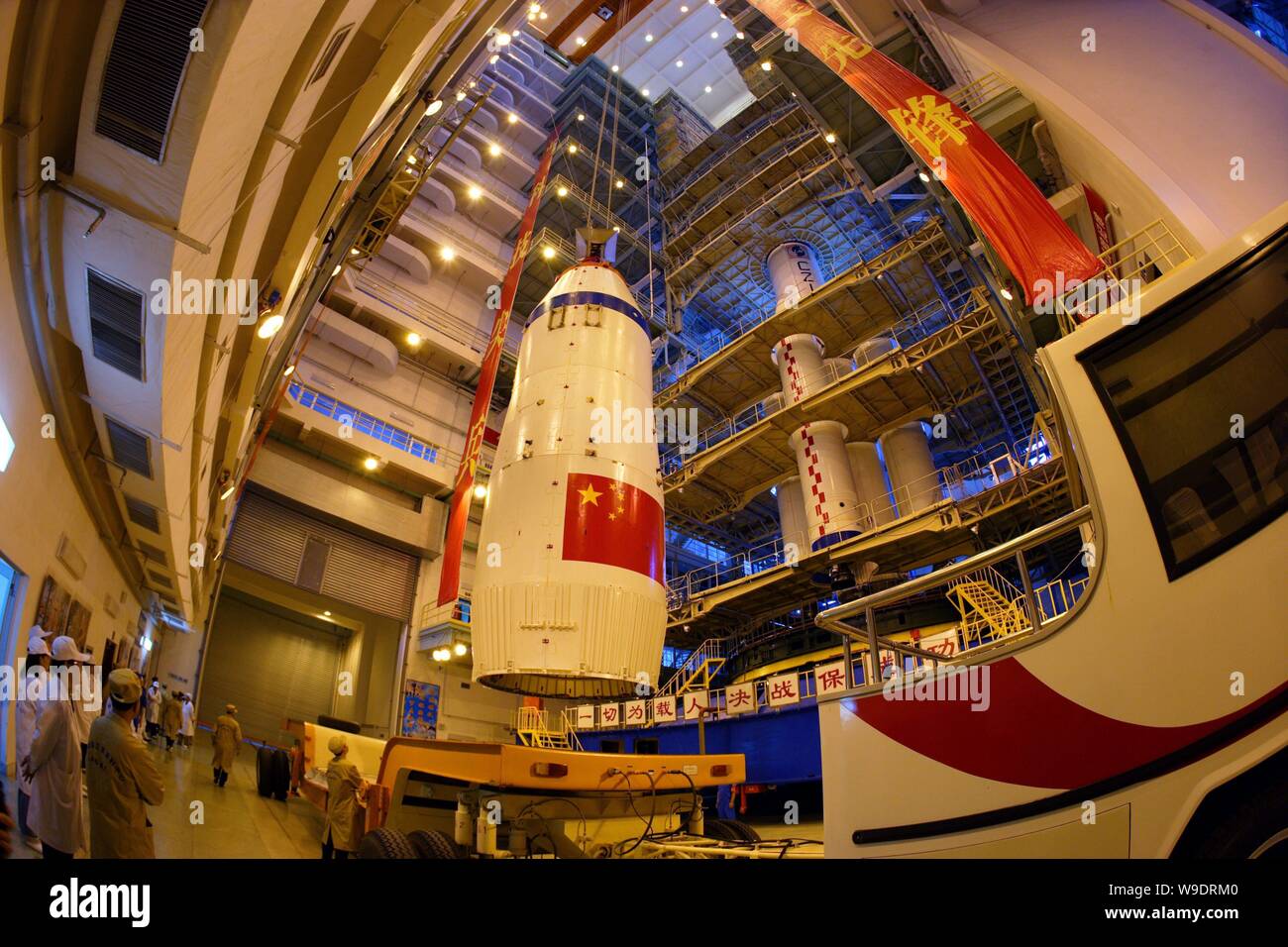 Chinese aeronautical scientists and workers unload the Shenzhou VII ...