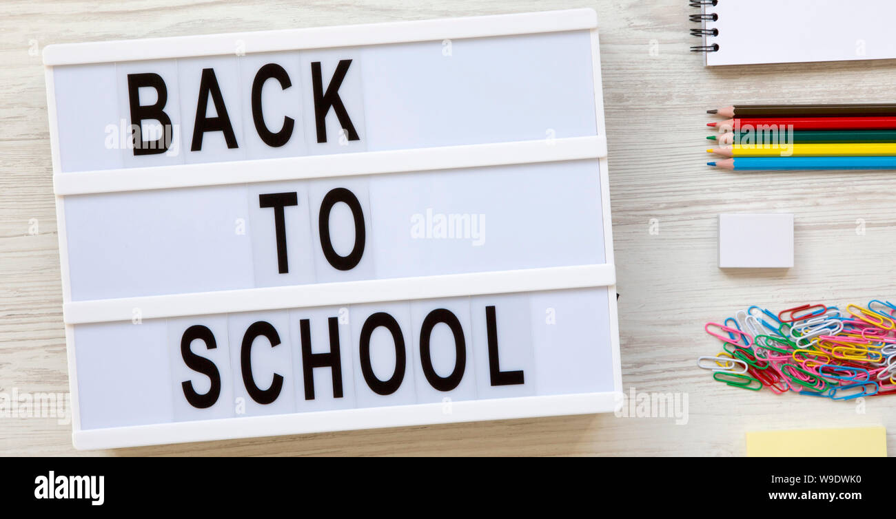 'Back to school' words on a lightbox, accessories for study on a white ...