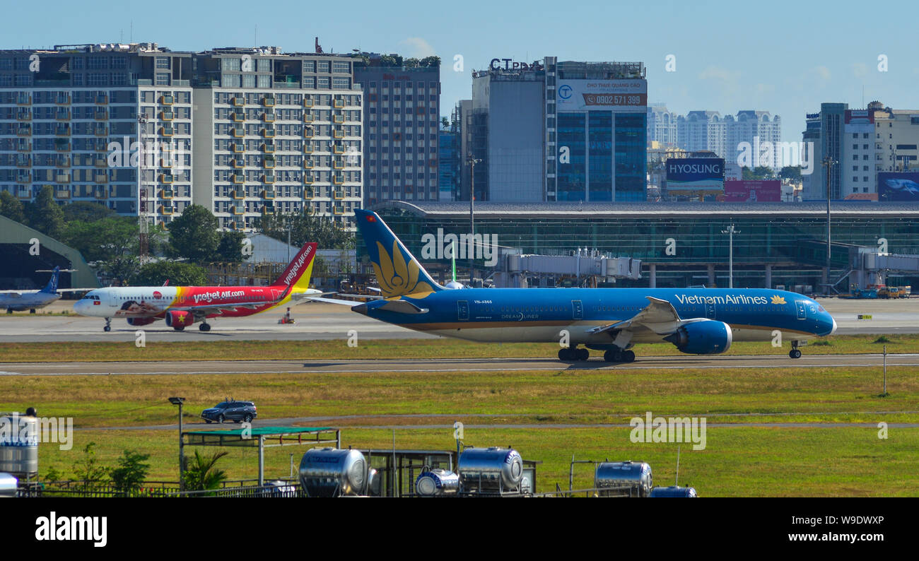 Saigon, Vietnam - Feb 19, 2019. Passenger airplanes taxiing on runway ...