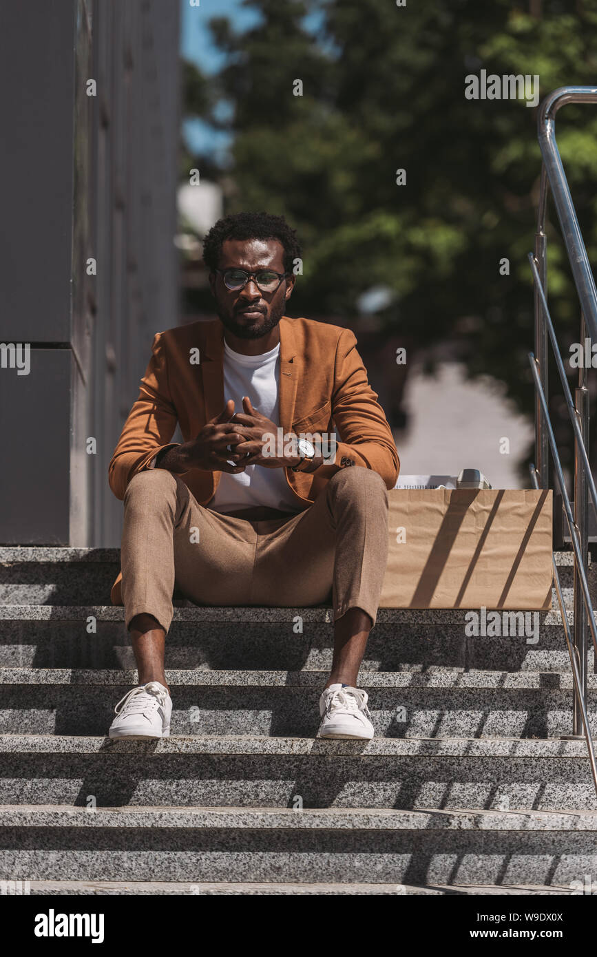 Businessman sitting on stairs hi-res stock photography and images - Alamy
