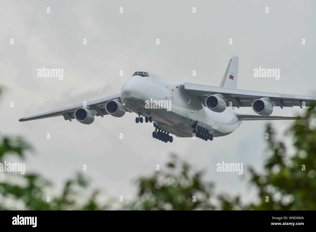 Heavy cargo aircraft landing at the airport in sunny day Stock Photo ...