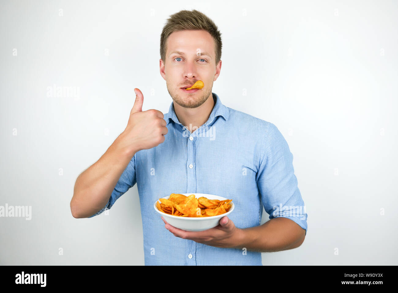 Young man eats spicy chips hi-res stock photography and images - Alamy