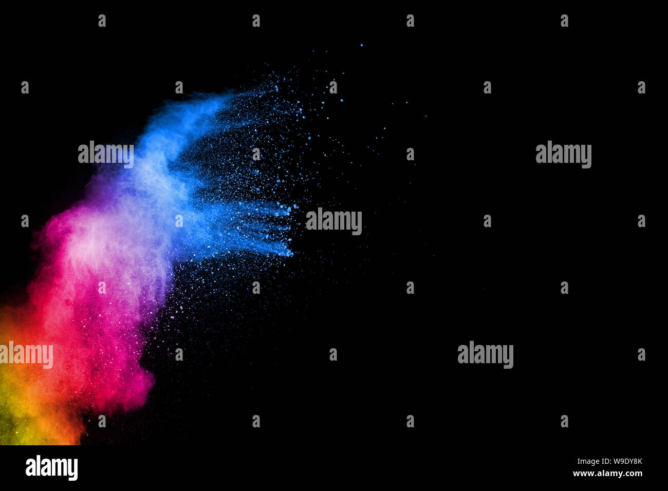 Abstract colorful powder explosion on black background.Freeze motion of ...