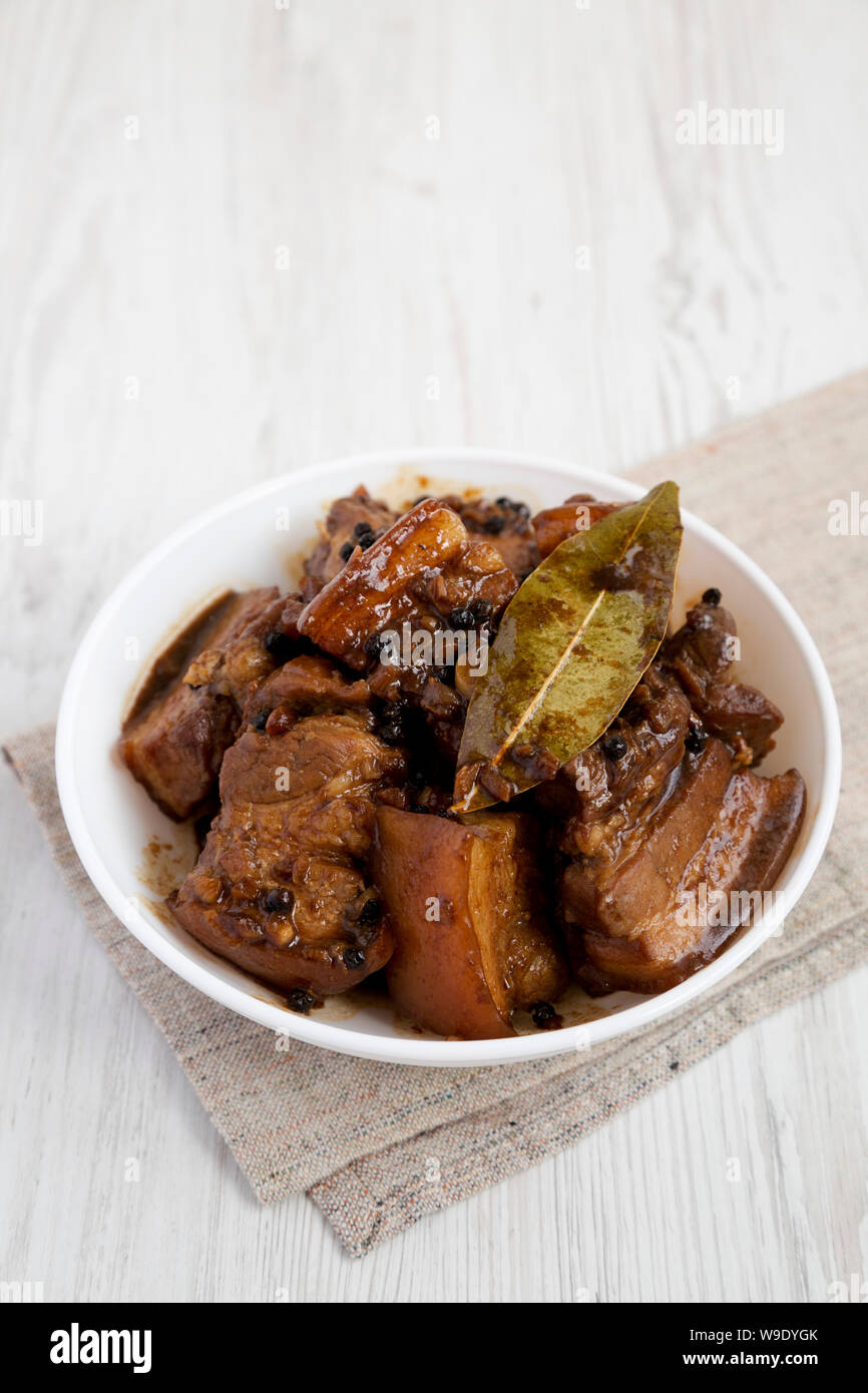 Homemade Filipino Adobo Pork on a white wooden background, side view ...