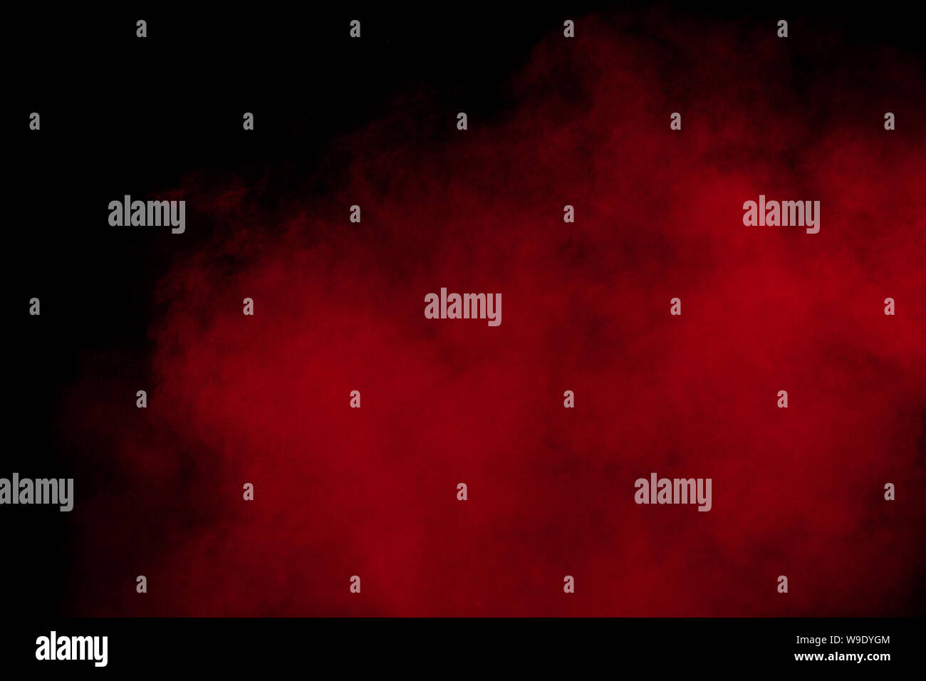Red color powder explosion on black background.Freeze motion of red ...
