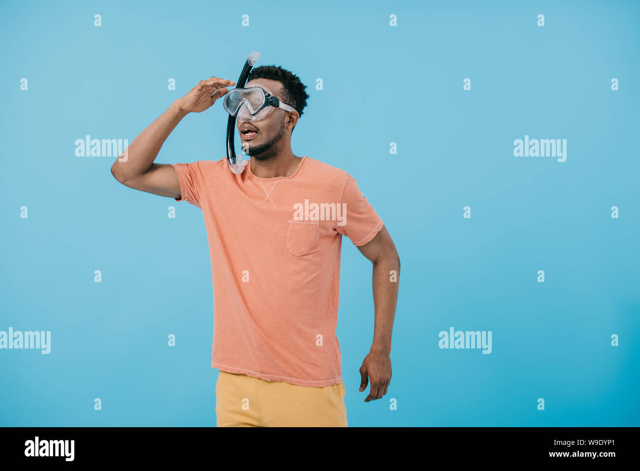 african american man in diving mask standing isolated on blue Stock ...