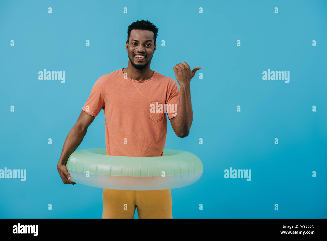 happy african american man showing thumb up and standing with ...