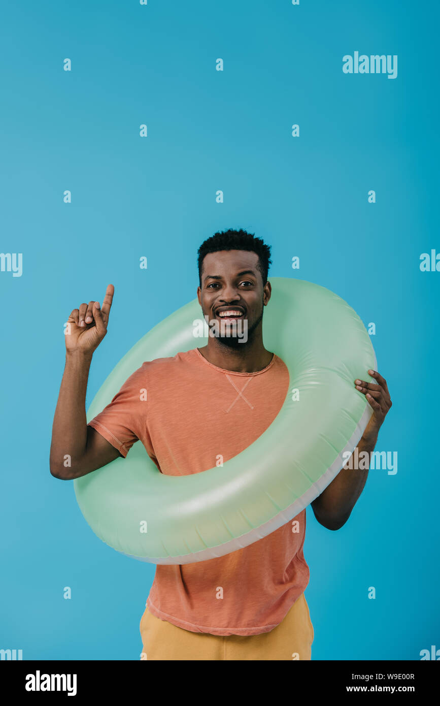 happy african american man pointing with finger and standing with ...