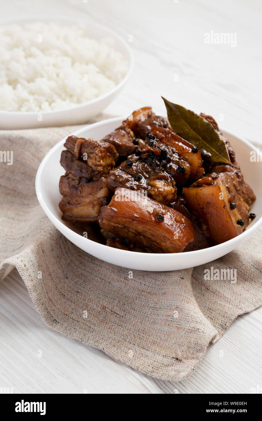Homemade Filipino Adobo Pork with rice on a white wooden background ...
