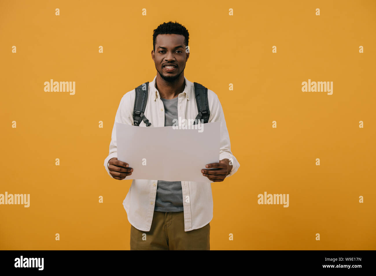 happy african american man holding blank paper isolated on orange Stock ...