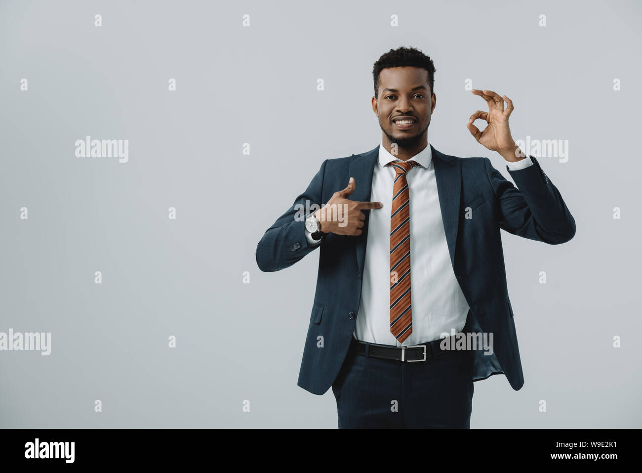 happy african american man pointing with finger at ok sign isolated on ...